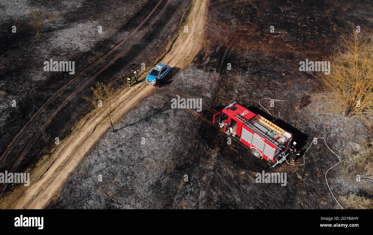 Wildfire aftermath - Firefighter engine and police car - aerial shot ...
