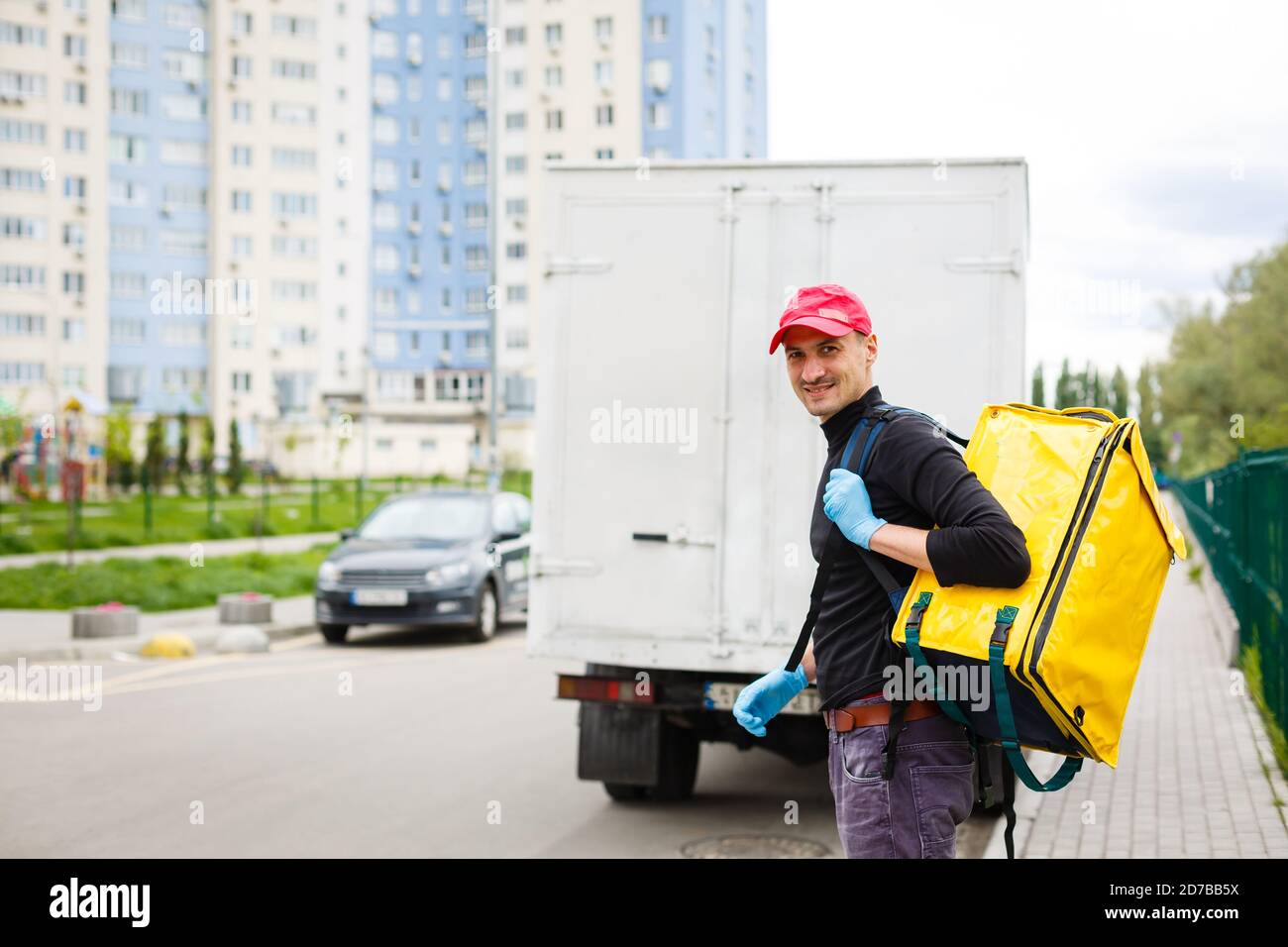 delivery boy of food delivery service walking down the street Stock ...