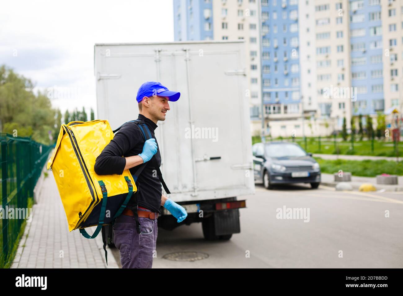 delivery boy of food delivery service walking down the street Stock ...
