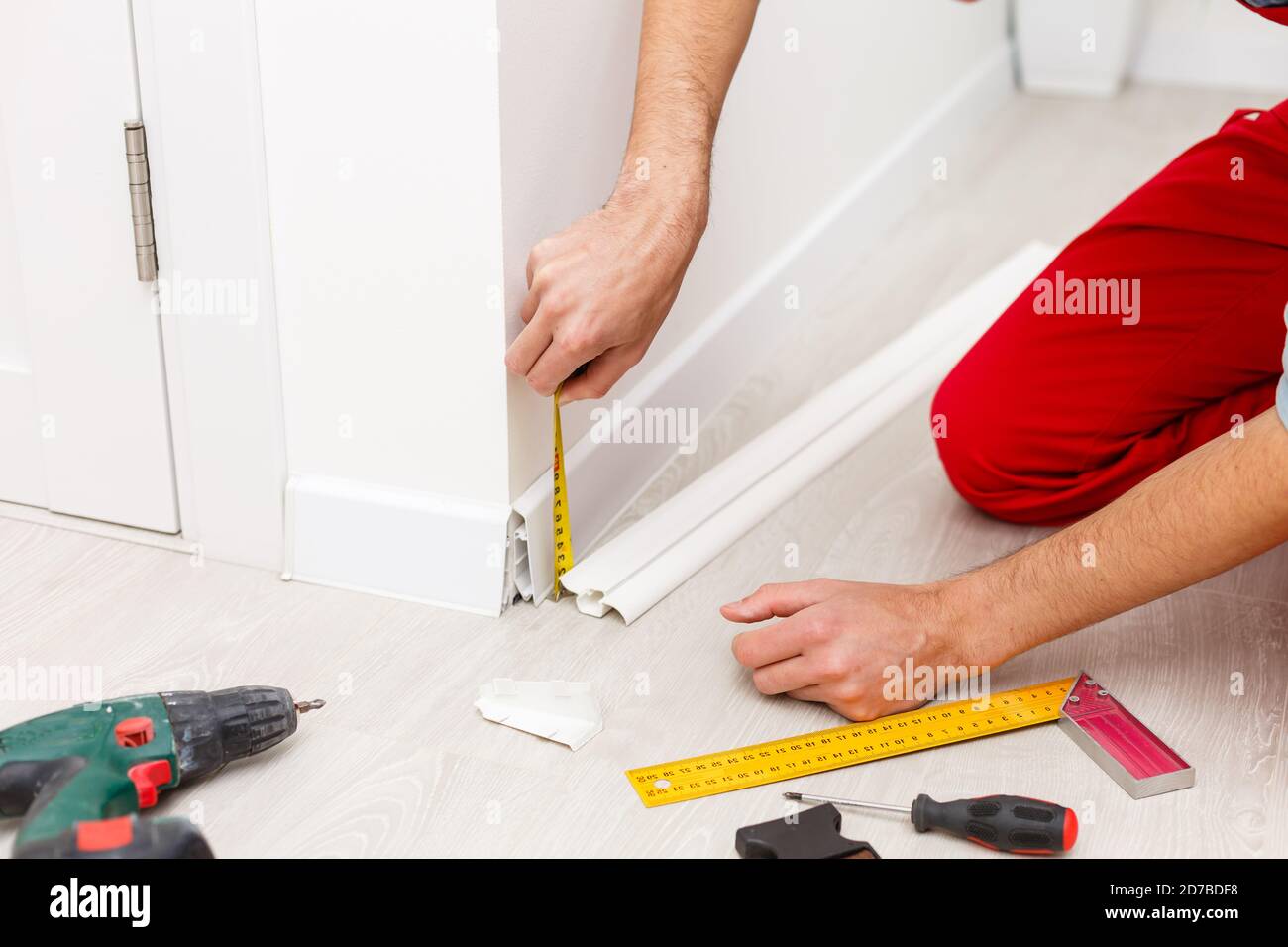 Repairman's Hands Installing Skirting Board Oak Wooden