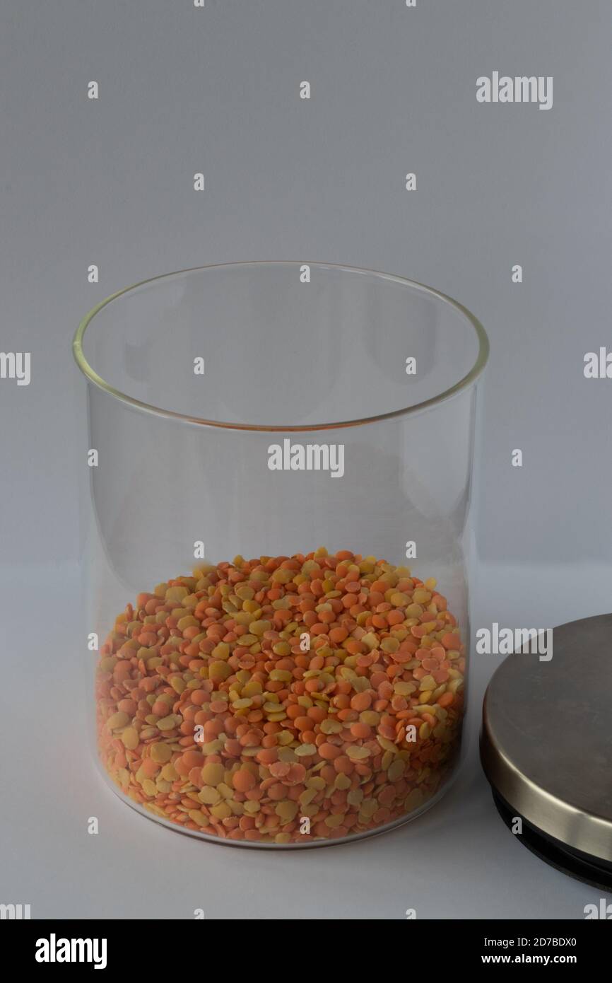 Glass pot full of red and yellow lentils Stock Photo - Alamy