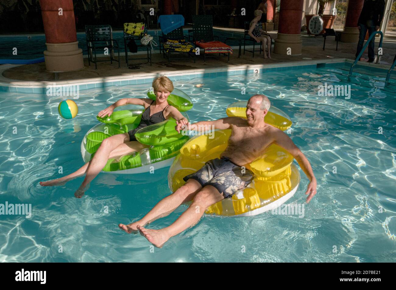 A retired couple floats in their community pool. Photo by Liz Roll ...