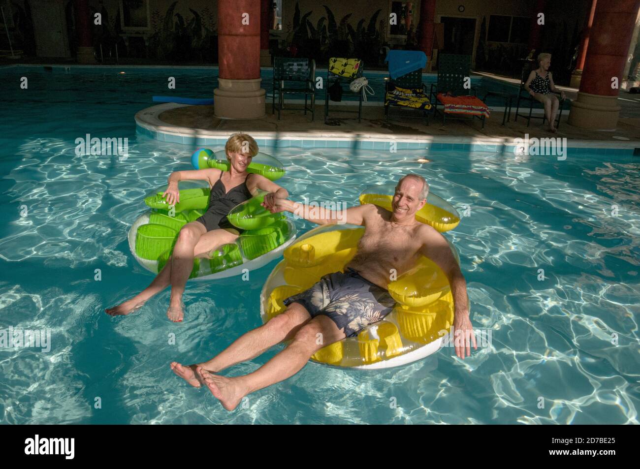 A retired couple floats in their community pool. Photo by Liz Roll ...