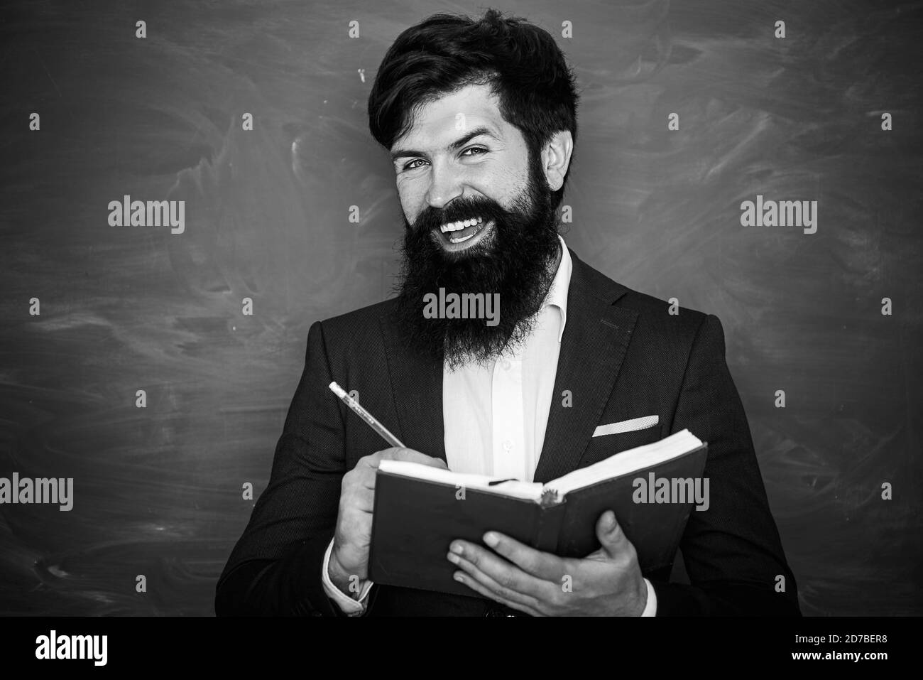 Bearded professor at school lesson at desks in classroom. Education ...