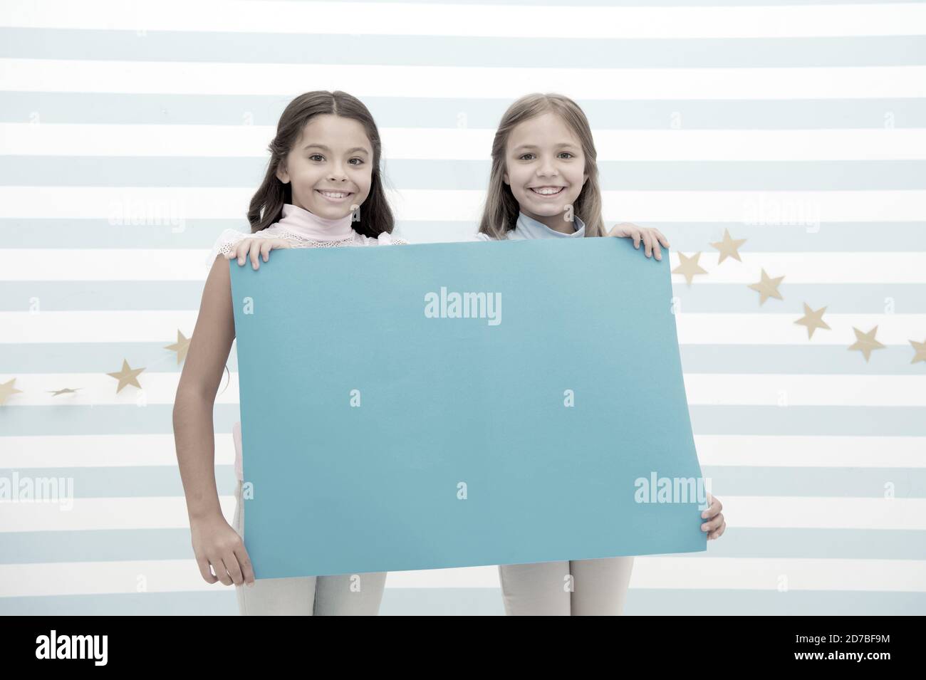 Kids announcement concept. Amazing surprising news. Girl hold ...