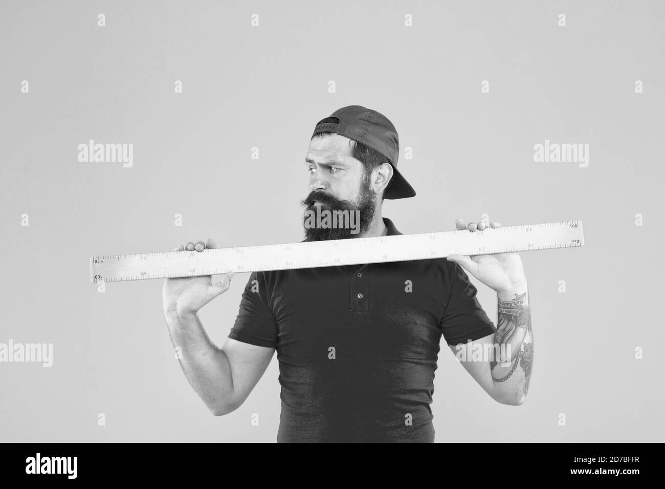 Measuring with ruler. School teacher hold ruler yellow background ...