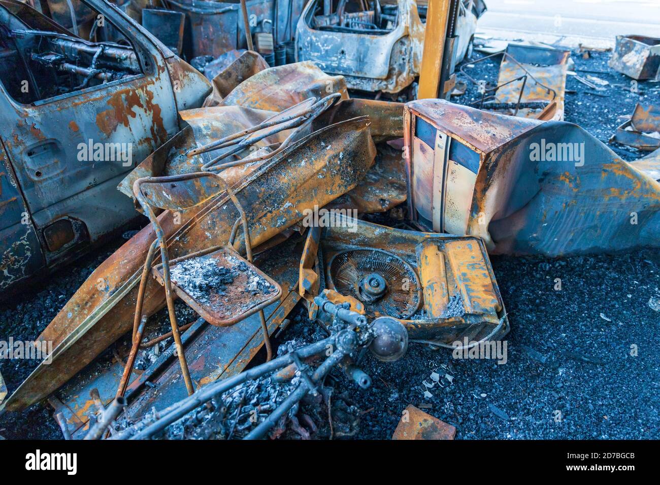 Ash surrounds chair and other twisted metal after destructive fire ...