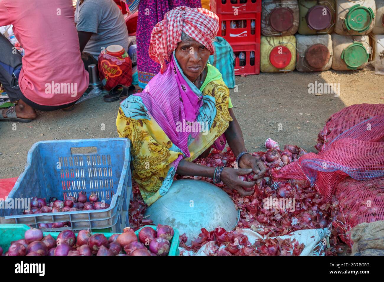 An old woman Indian stallholder in colourful local dress in a stall ...