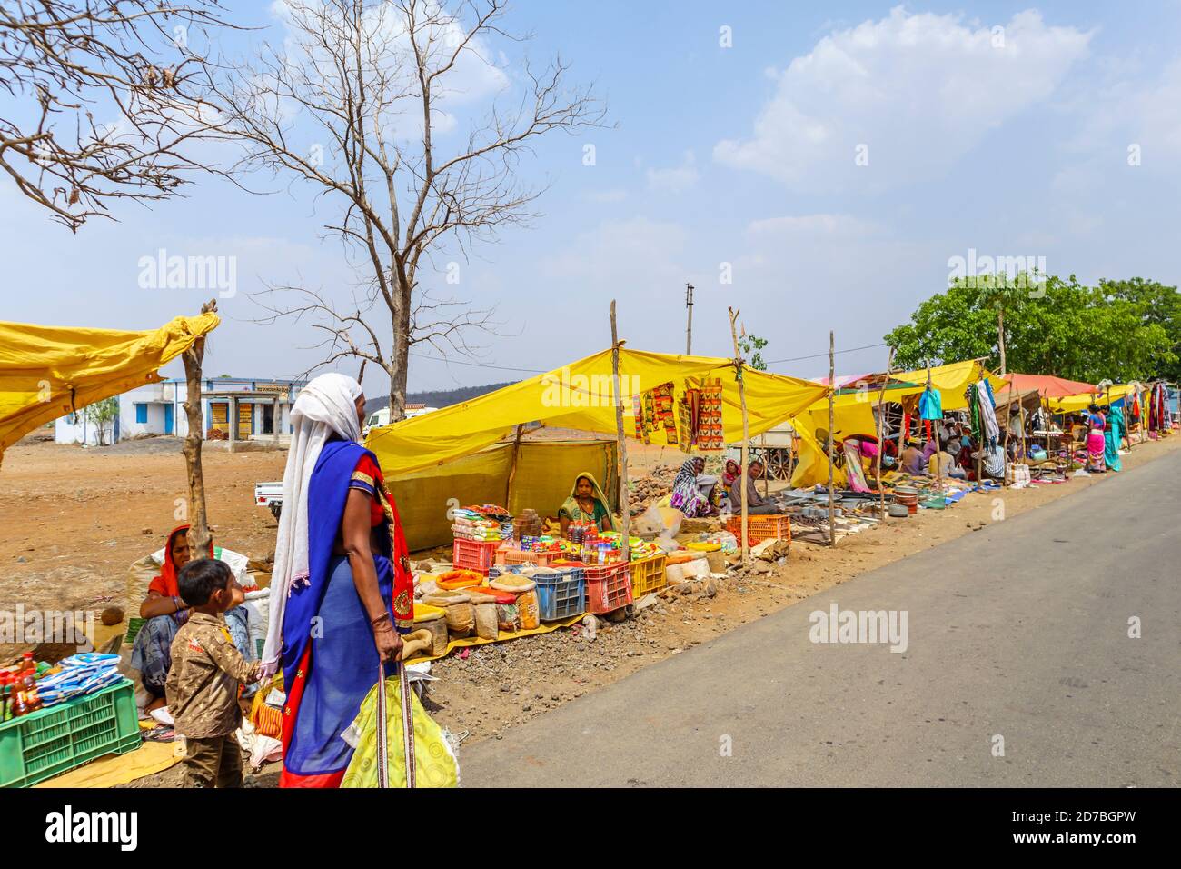 Temporary stalls selling local produce and goods in a roadside market ...
