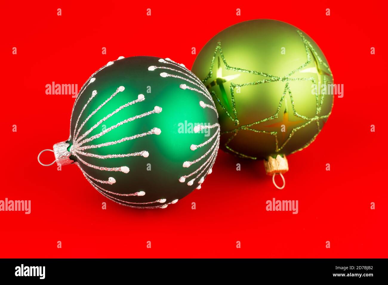 Christmas two green balls on red background Stock Photo - Alamy