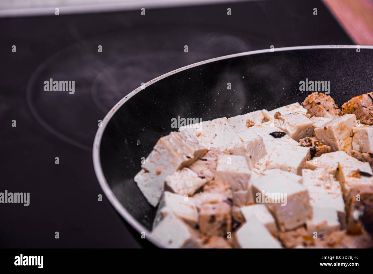 Macro shot of fried tofu mix in oil making smoke Stock Photo - Alamy