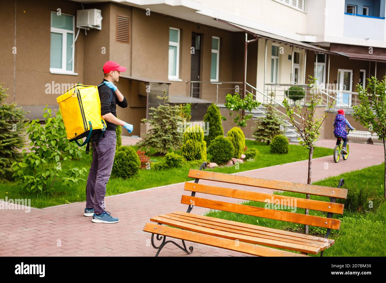 delivery boy of food delivery service walking down the street Stock ...