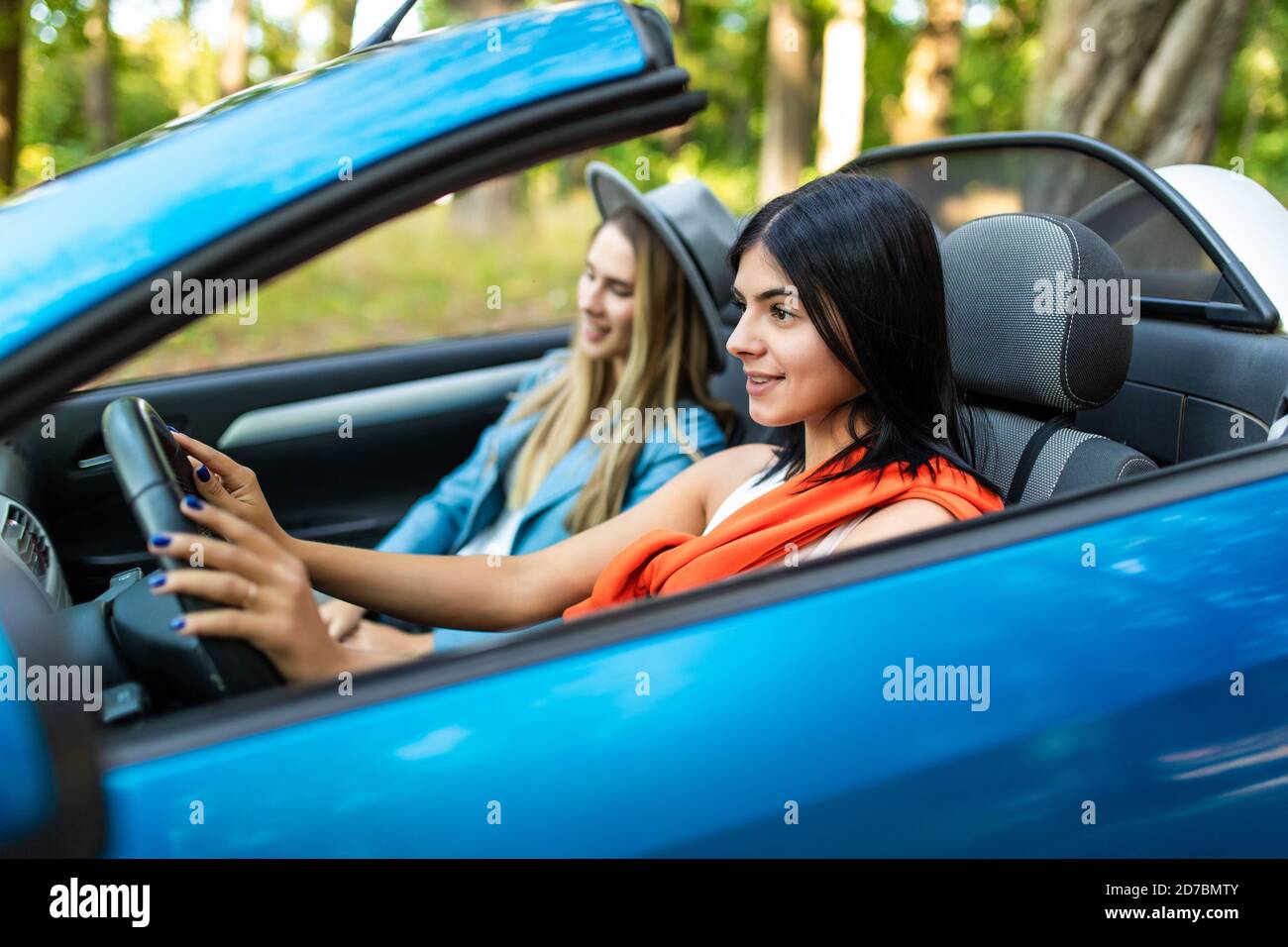Two Female Friends On Road Trip Driving In Convertible Car Stock Photo ...
