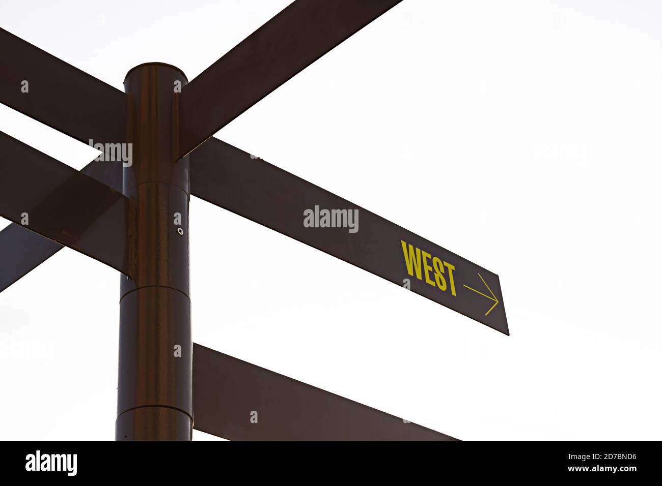 Dark coloured multidirectional signpost with applied direction to WEST ...