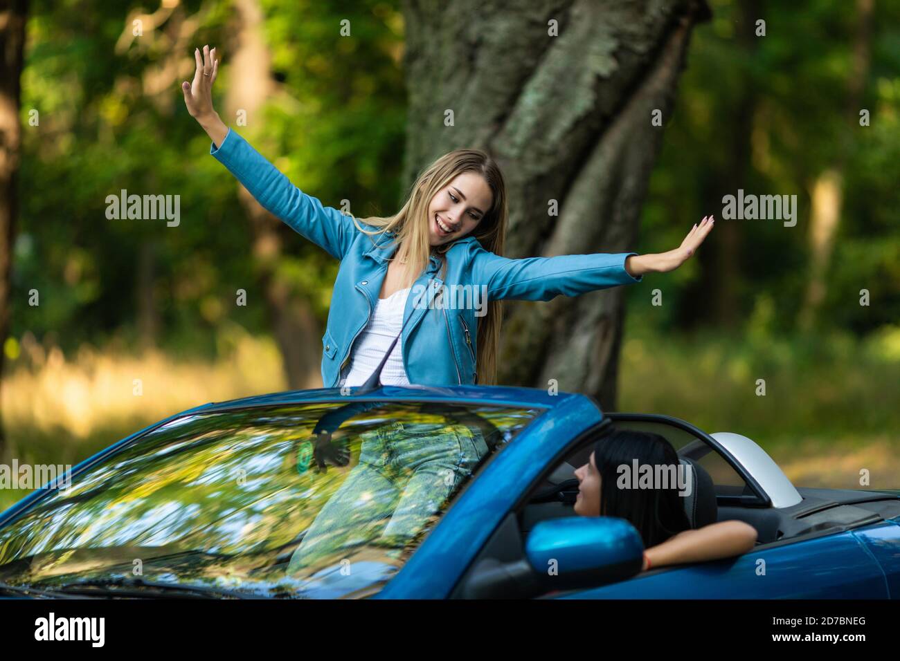 Happy Woman Raising Hand In Car While Travelling Stock Photo - Alamy
