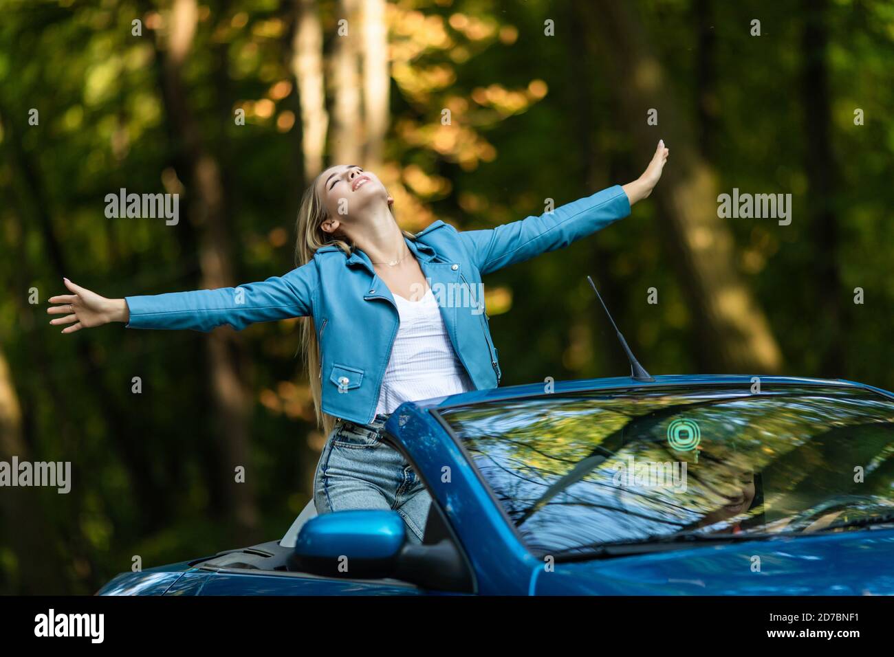 Happy Woman Raising Hand In Car While Travelling Stock Photo - Alamy