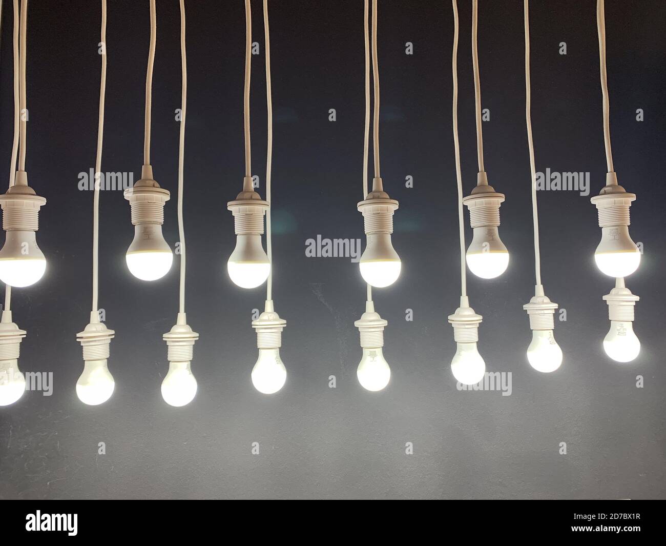 White lamps turned on over black background Stock Photo - Alamy