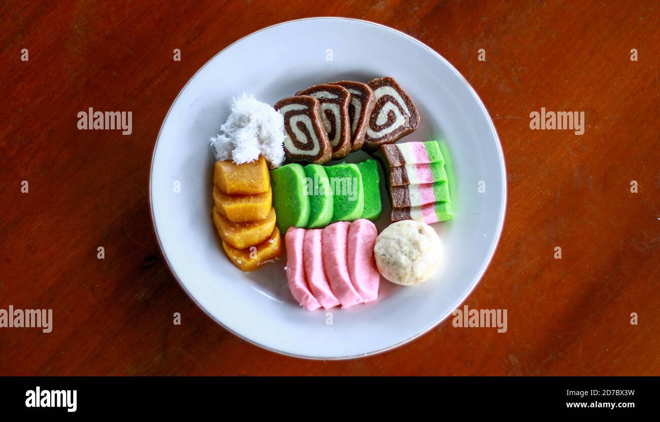 Getuk Gondok on white plate on wood background. Getuk is traditional ...