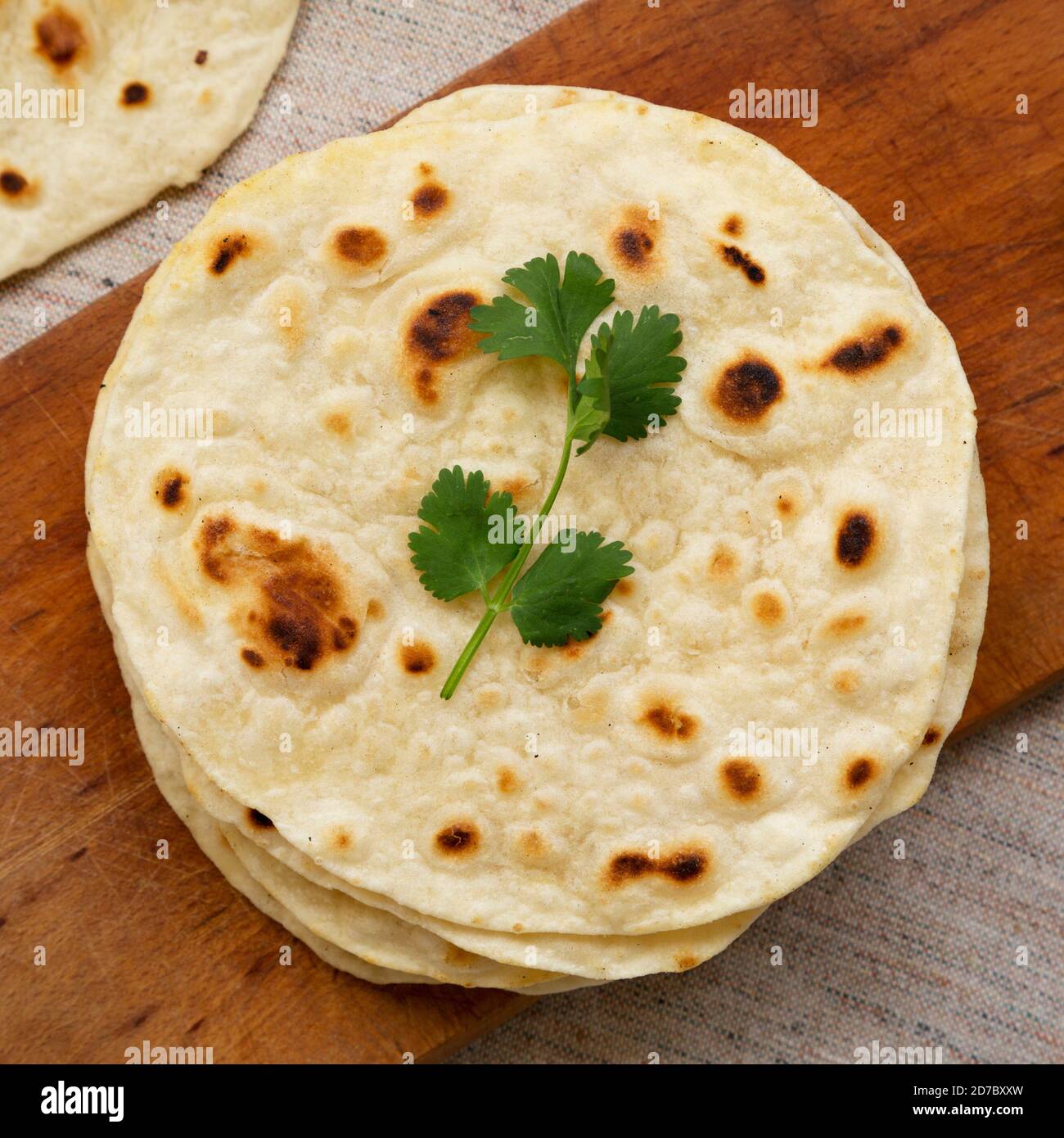 Homemade Roti Chapati Flatbread on a rustic wooden board, overhead view ...