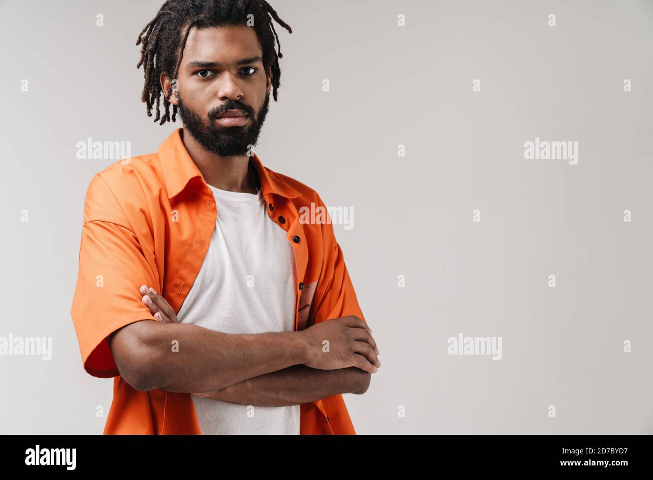 Image of serious african guy posing isolated over grey wall background ...