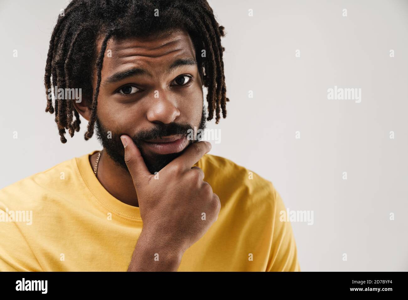Image of a serious thoughtful african guy isolated over grey wall ...