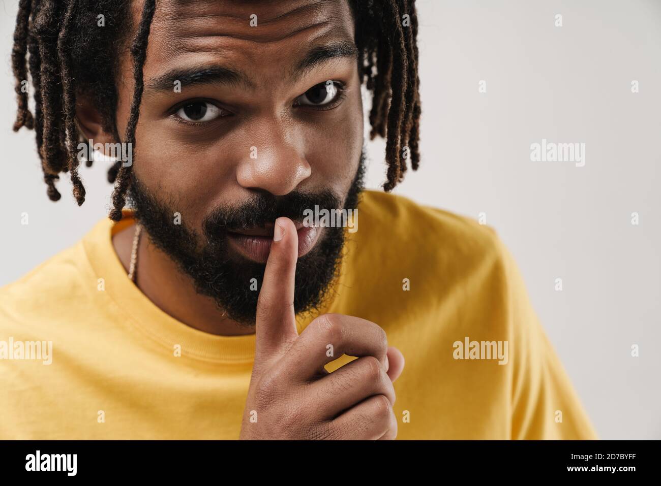 Image of a positive african guy isolated over grey wall background ...
