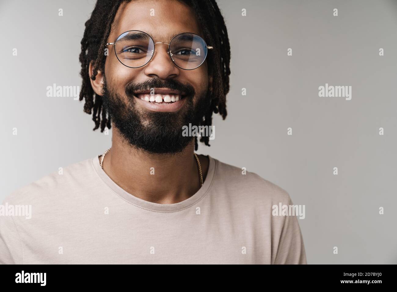 Image of happy positive african guy posing isolated over grey wall ...