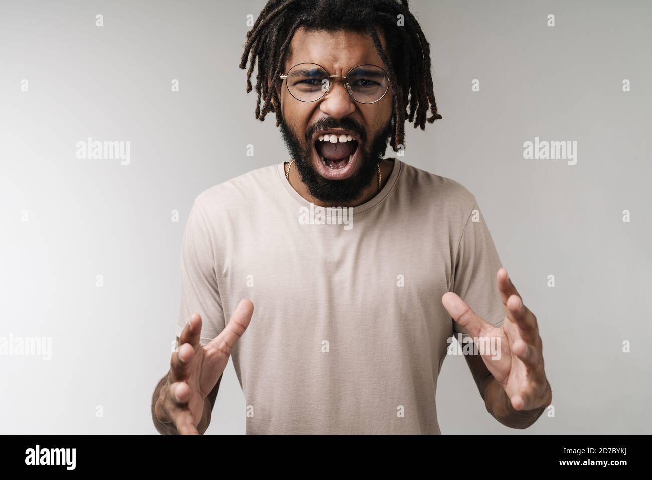 Image of screaming stressed african guy isolated over grey wall ...