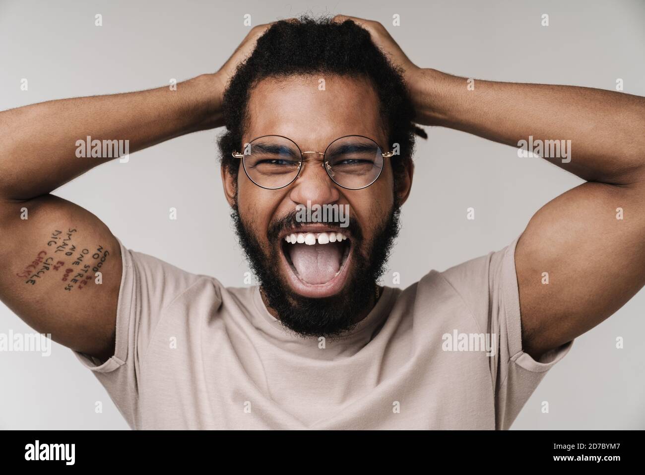 Image of screaming stressed african guy isolated over grey wall ...