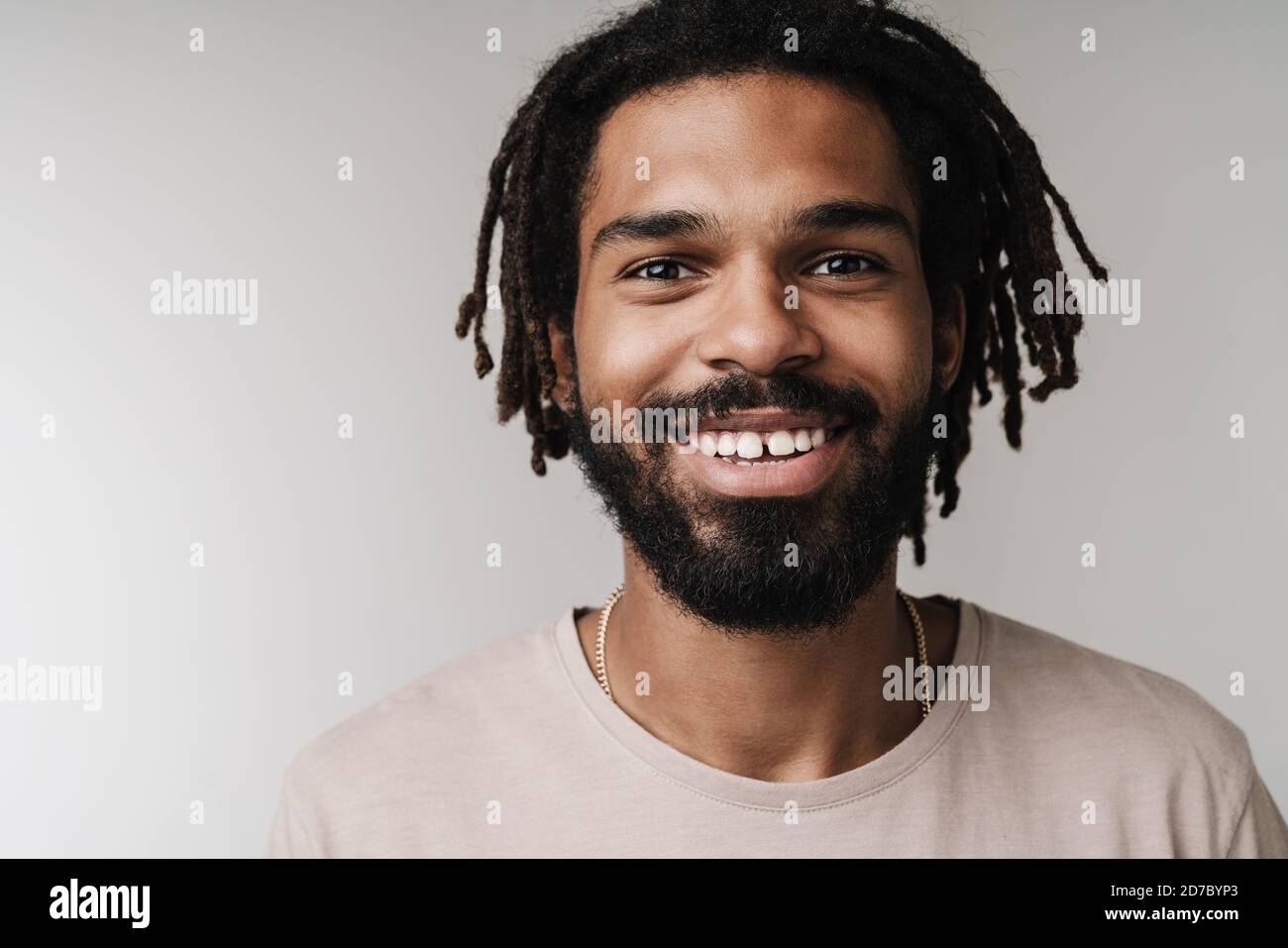 Image of happy cheerful african guy posing isolated over grey wall ...