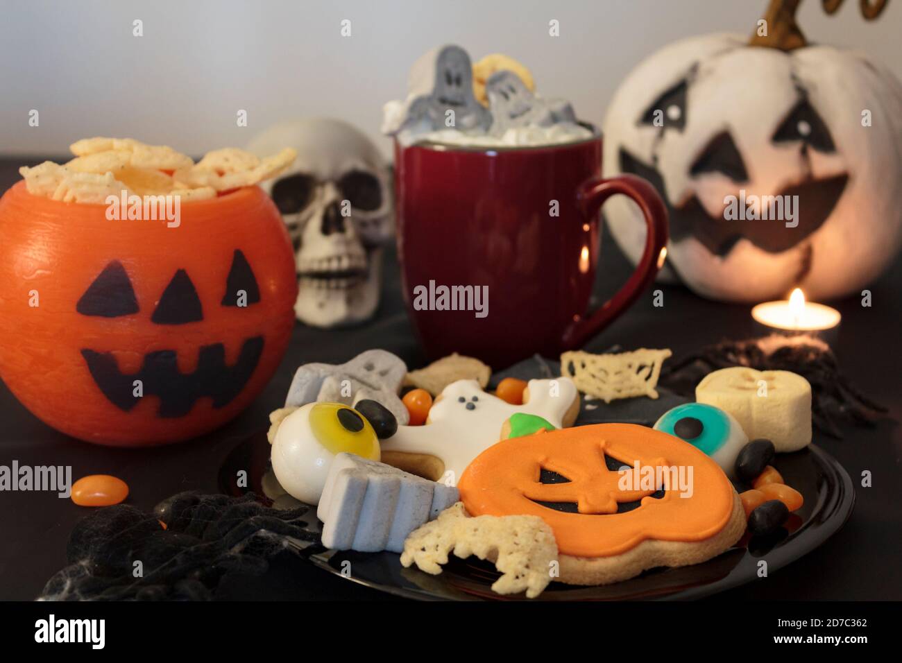 Halloween table with spooky treats and snacks, hot drink and scary ...