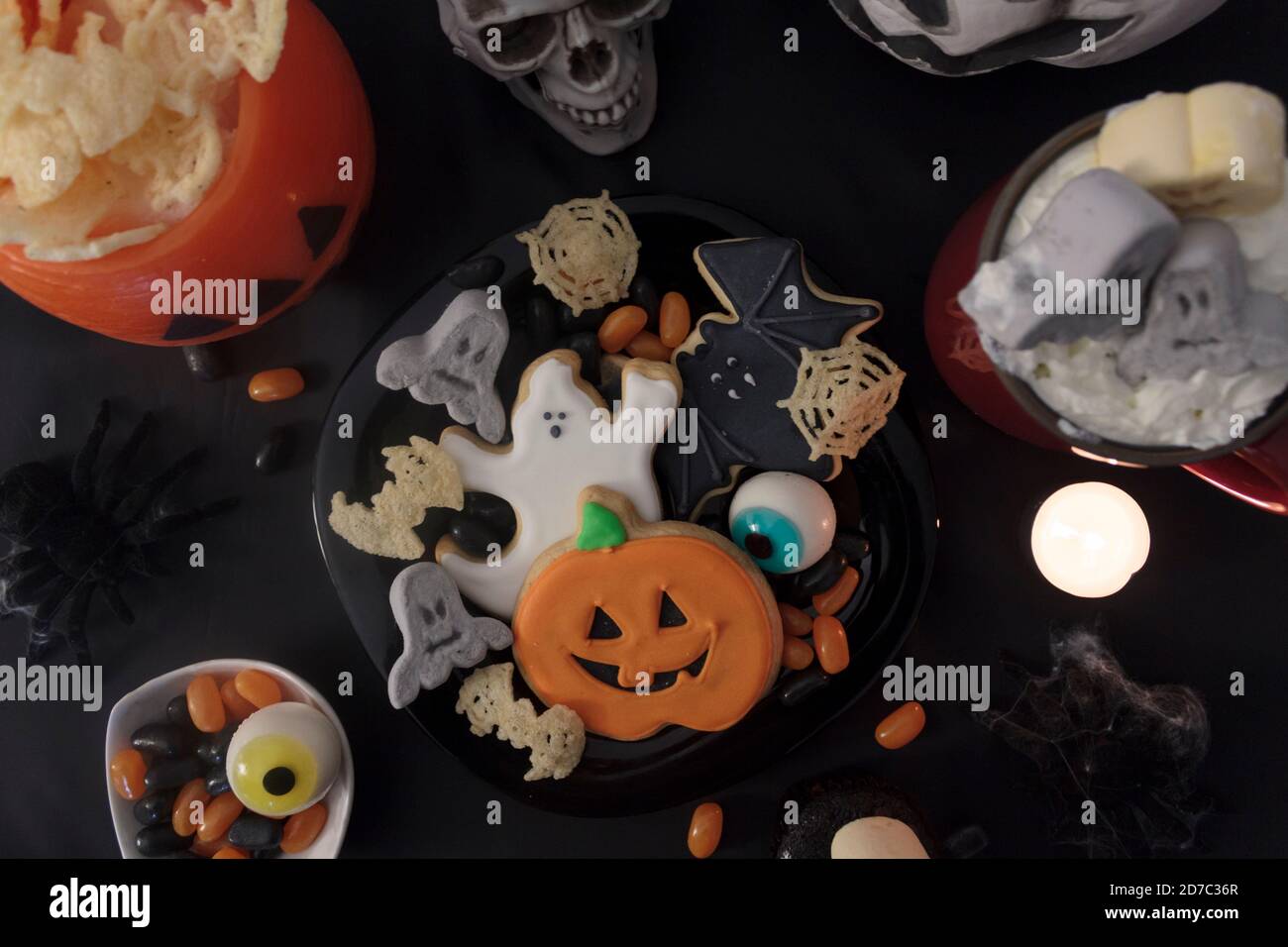 Top view of Halloween table with spooky treats and snacks, hot drink ...