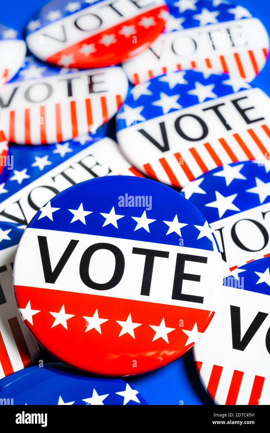 A group of red, white and blue VOTE button on a blue background Stock ...