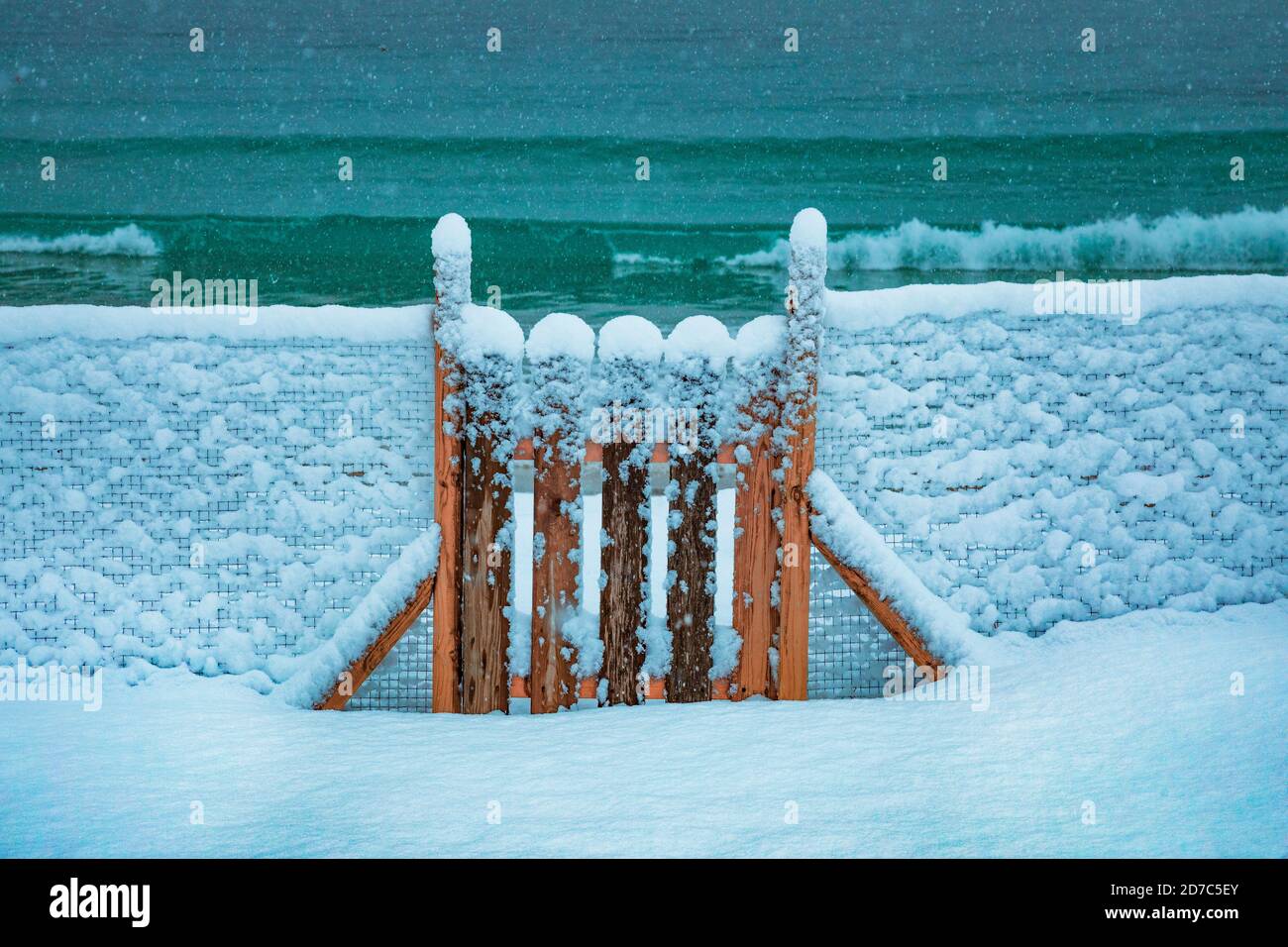 Heavy snow from snowstorm resting on fence post in the Lofoten Islands ...