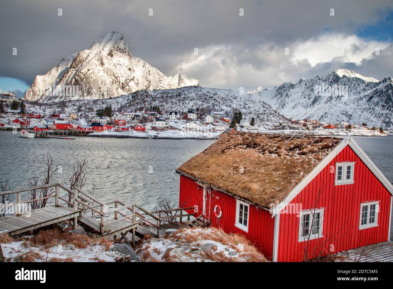 Typical Norwegian red fishing huts (rorbu) with green grass roof ...