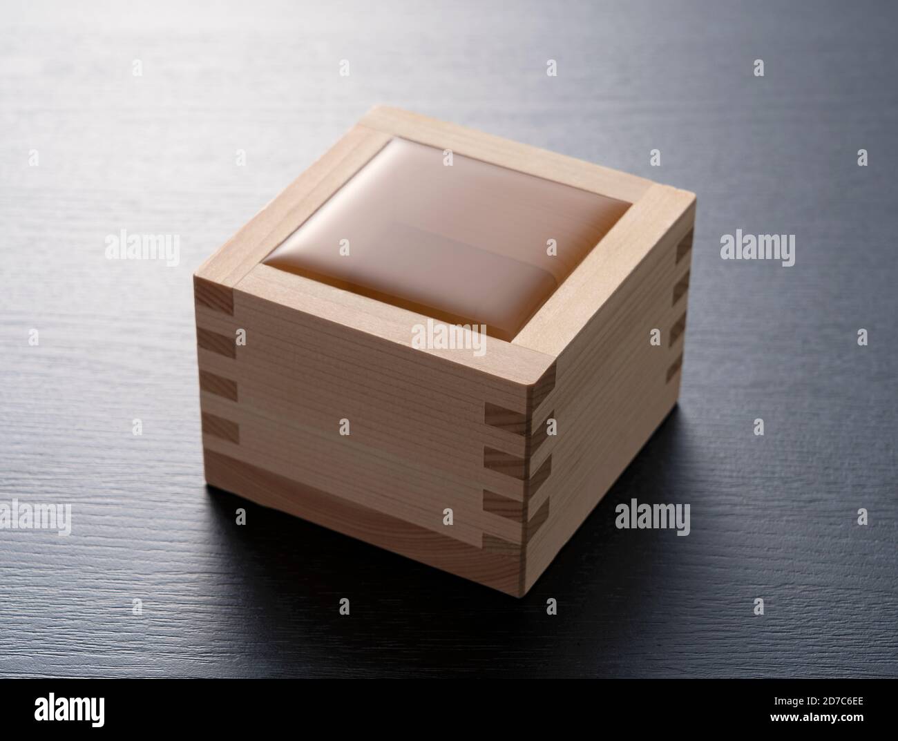 A Japanese sake box with a black background Stock Photo - Alamy