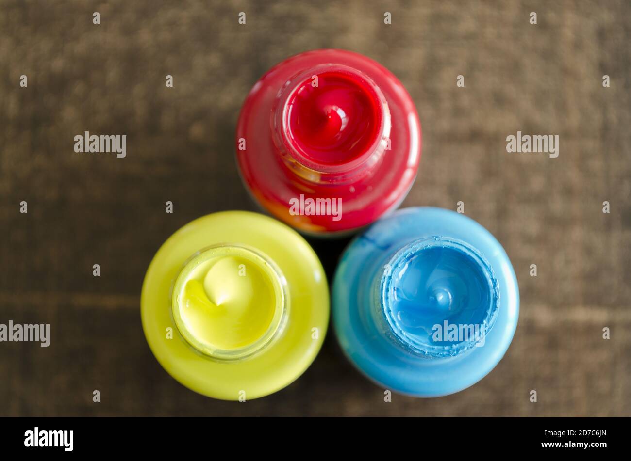 Top view of red, yellow, and blue acrylic paint containers Stock Photo ...