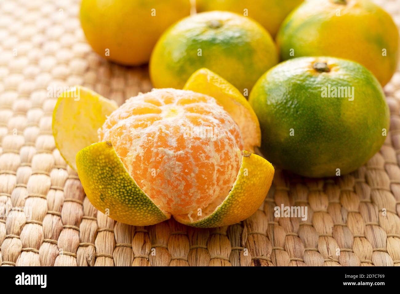 Peeled early Japanese tangerines on an Asian luncheon mat Stock Photo ...