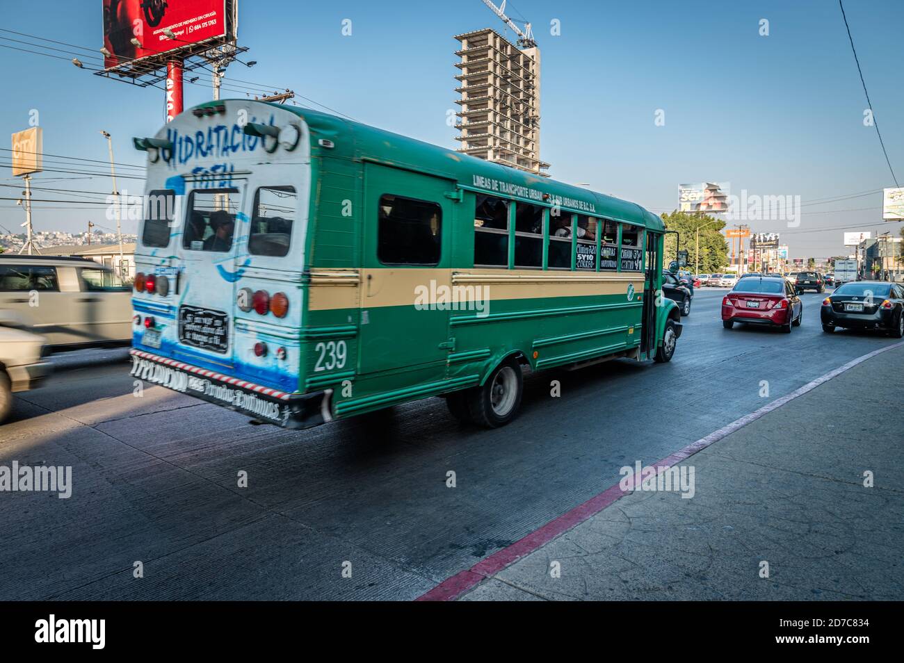 Green public transportation bus on busy street in Tijuana, Mexico Stock ...
