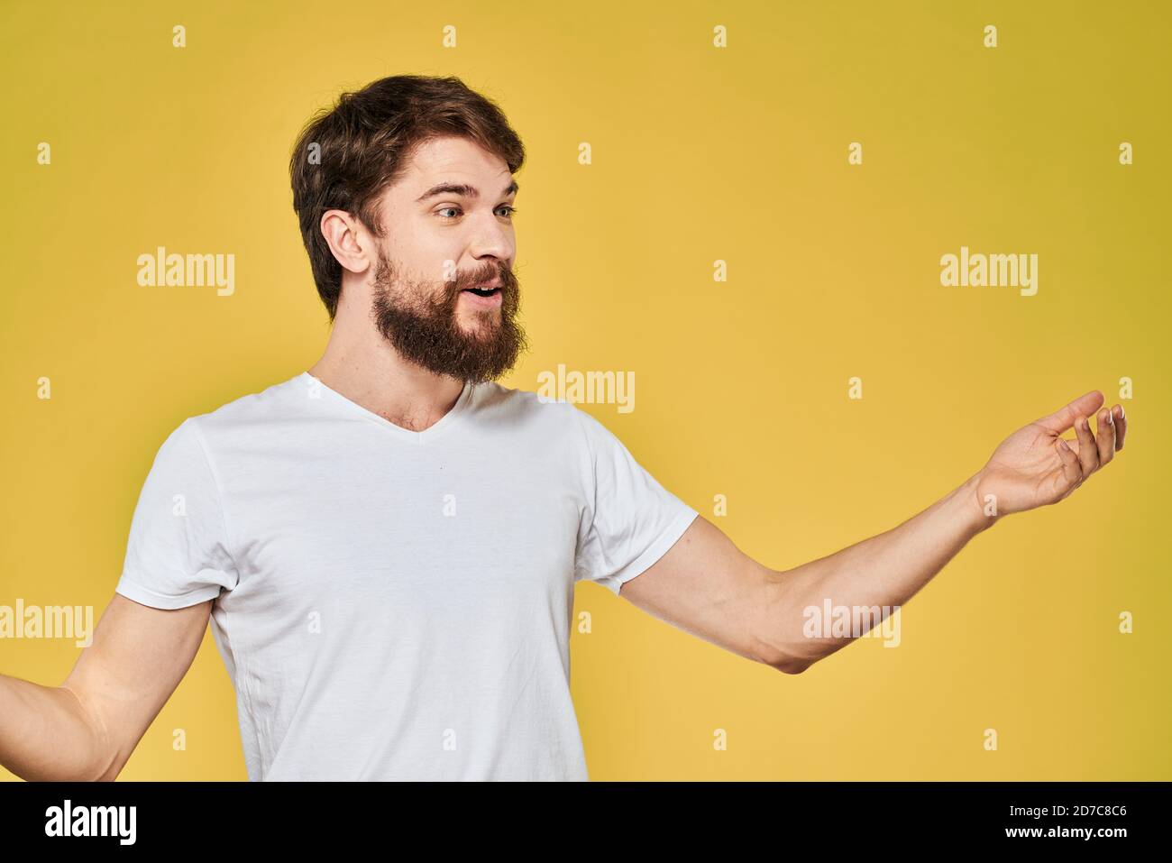 Man gesturing with hands emotions lifestyle white t-shirt yellow ...