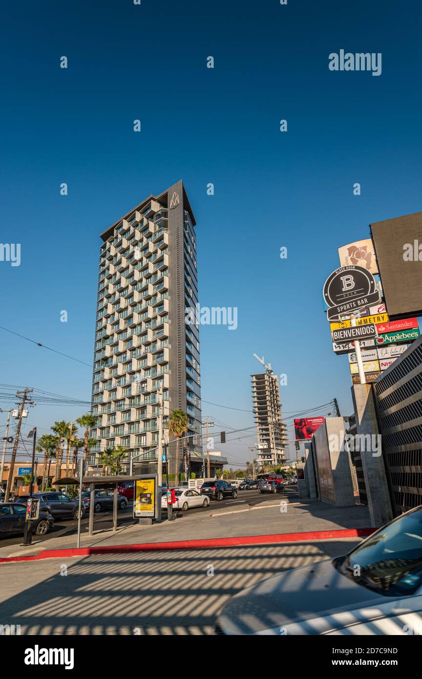Billboards on mall and modern apartment building in Tijuana, Mexico ...