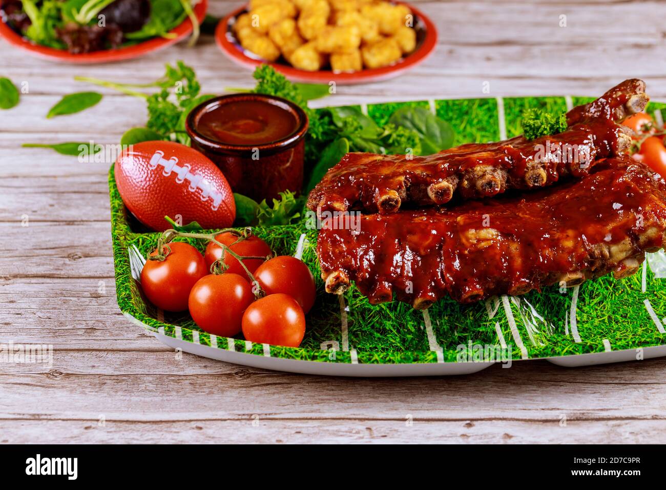 Tangy barbecue spare ribs with tomatoes for football party. Catering ...