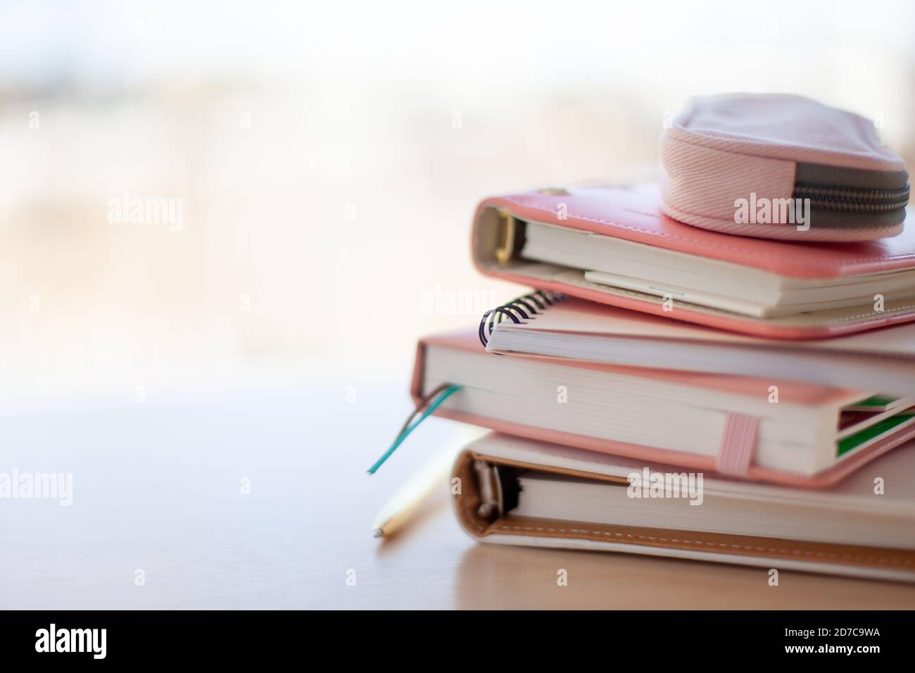 stylish designed coral and white coloured stack of diaries with gold ...