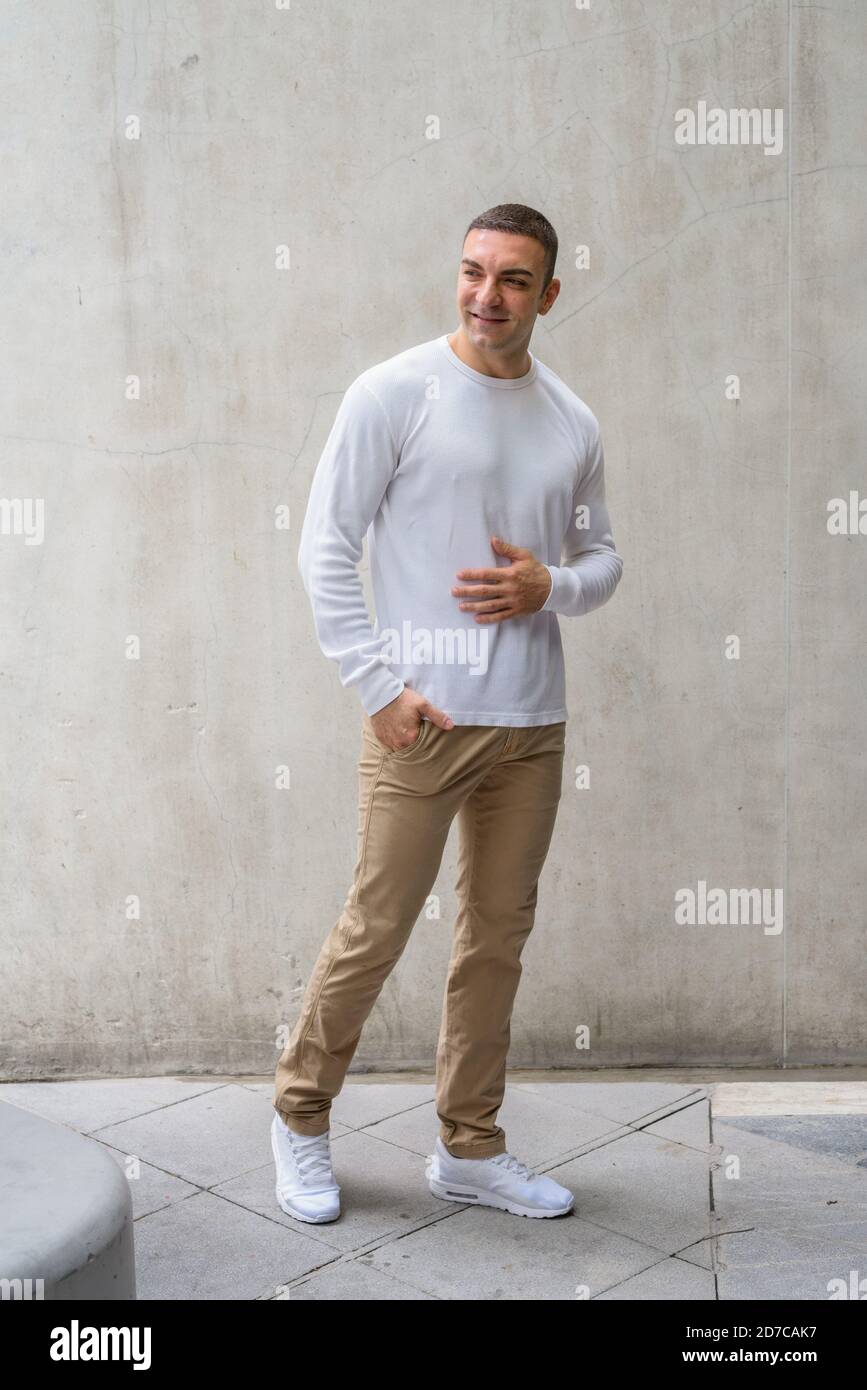 Full body shot of happy handsome man thinking and looking back Stock ...