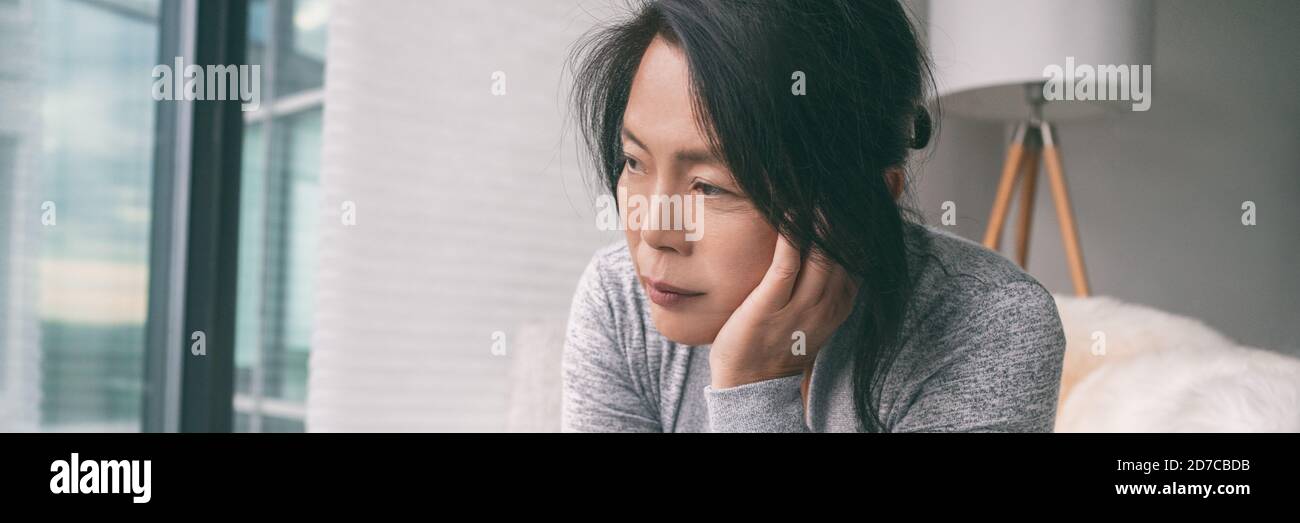 Sad depressed Asian woman having anxiety or depression during autumn ...