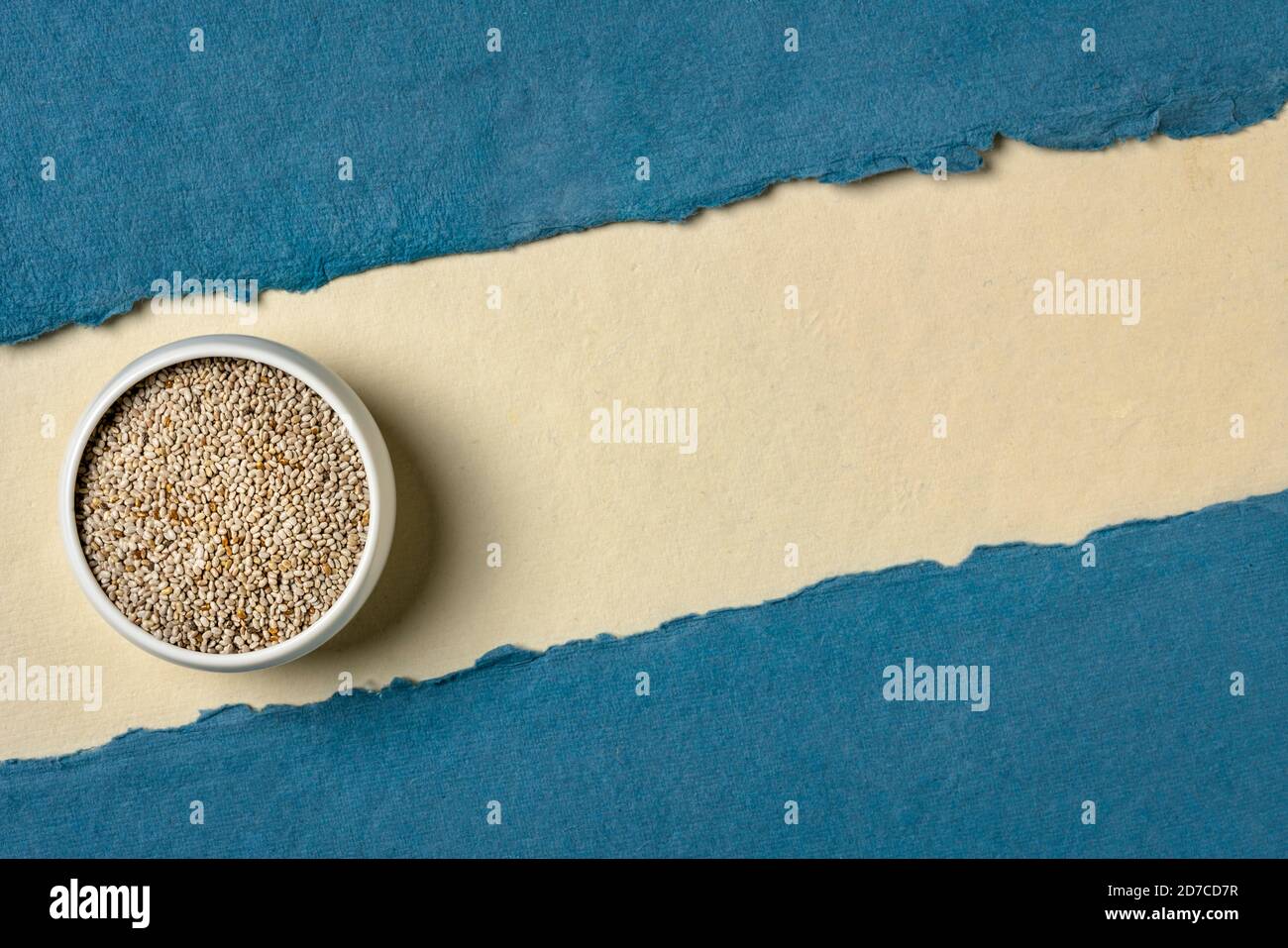 organic white chia seeds rich in omega-3 fatty acids, a small ceramic ...