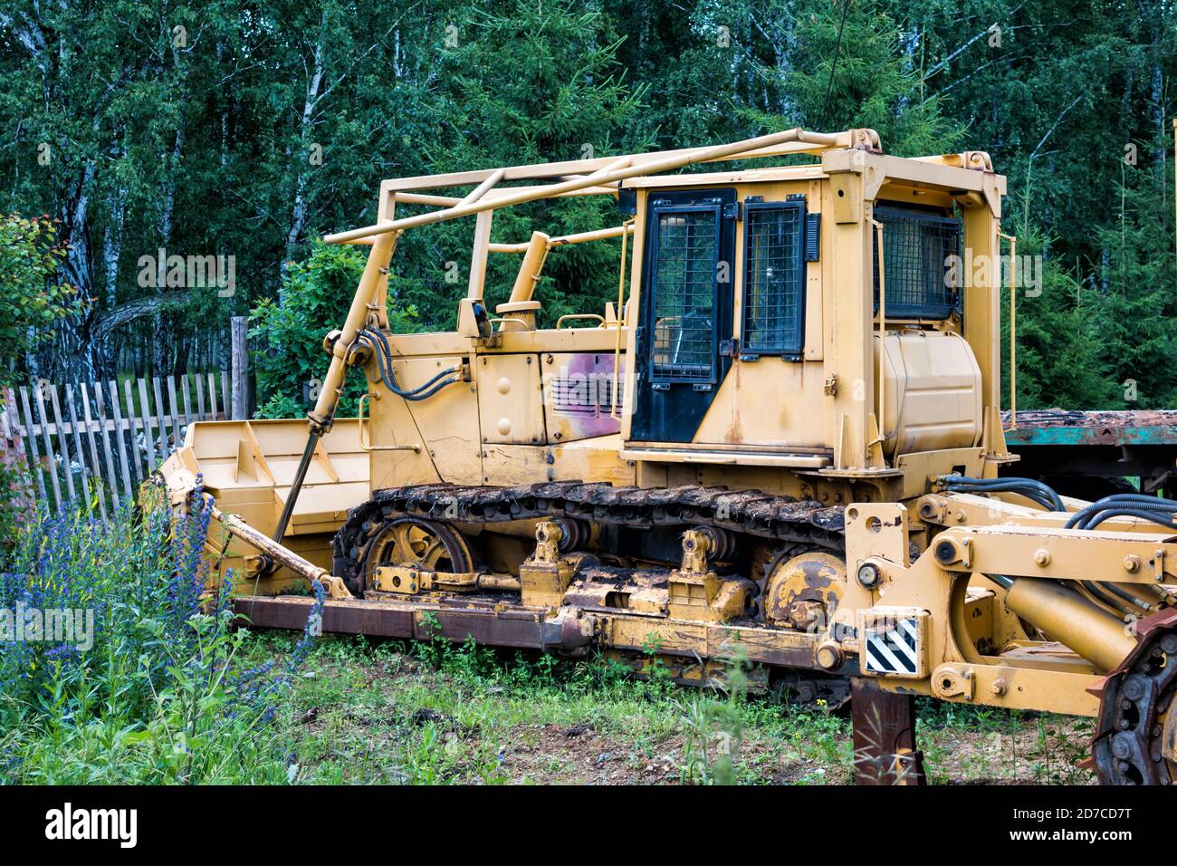 Yellow bulldozer in the forest Stock Photo - Alamy