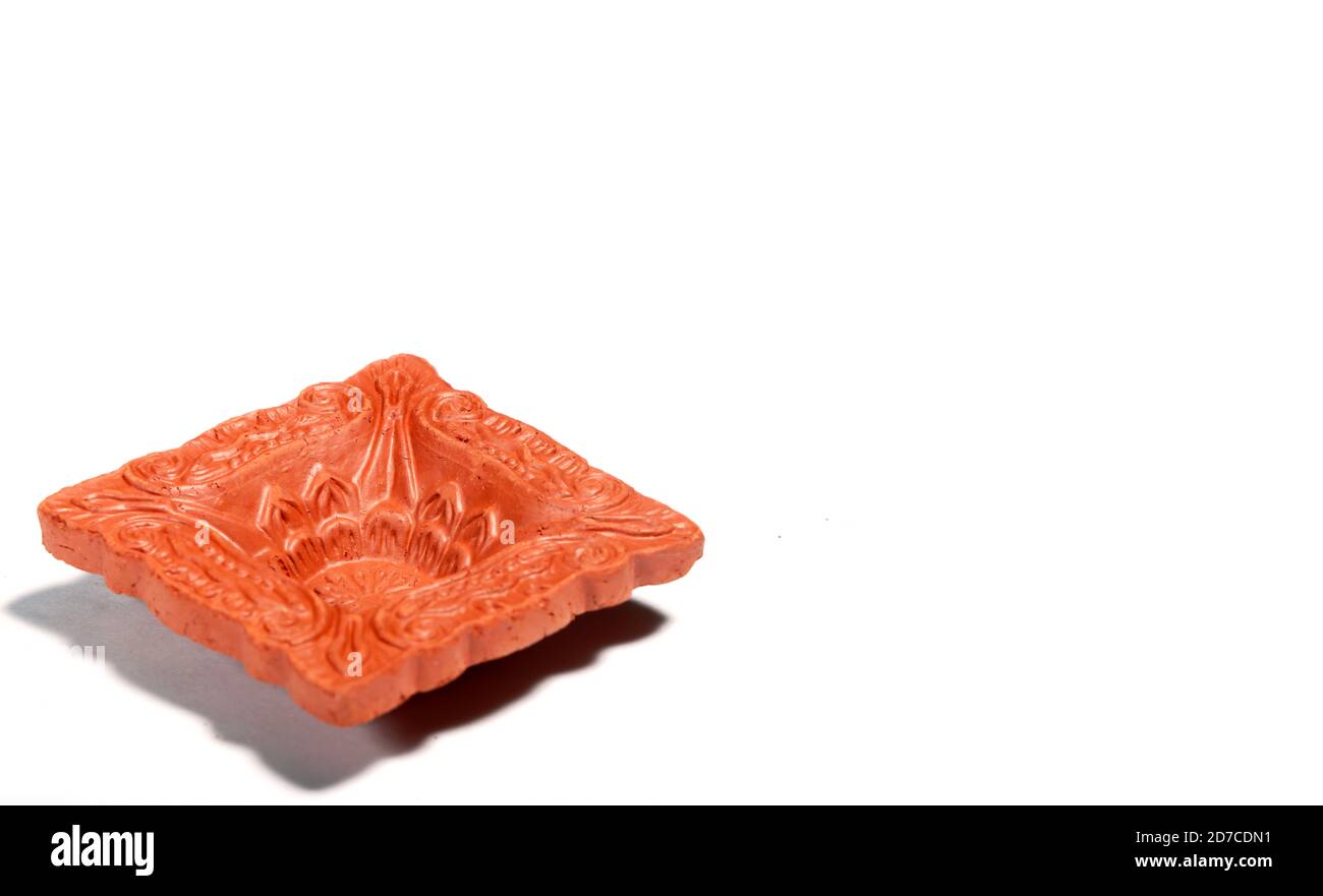 A close up of a beautifully designer handmade clay lamp isolated on ...