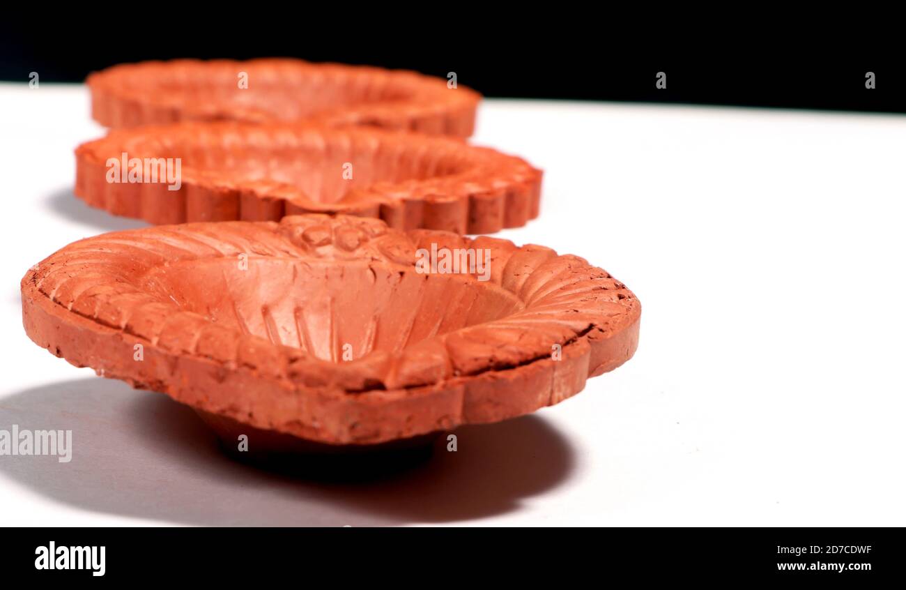 A close up of a beautifully designer handmade clay lamp isolated on ...