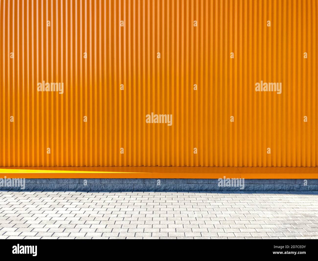 orange painted corrugated metal warehouse wall. facade of modern ...